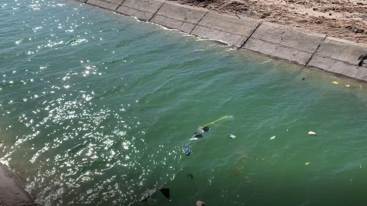 Garbage gathering along the Ktaiban irrigation canal | Human Rights Watch